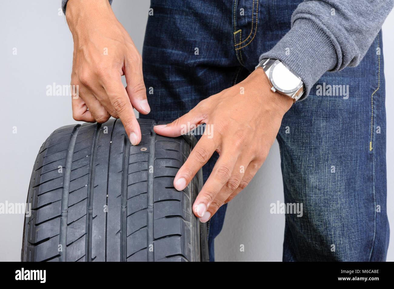 The man repairing flat car tire with repair kit, Tire plug repair kit ...