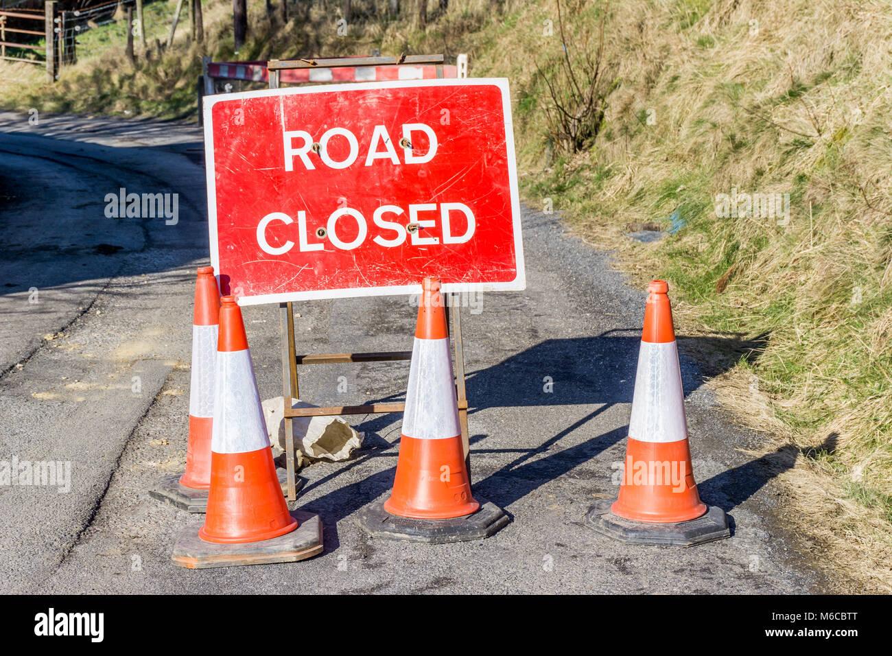 Road closed sign and traffic cones block English country road in ...