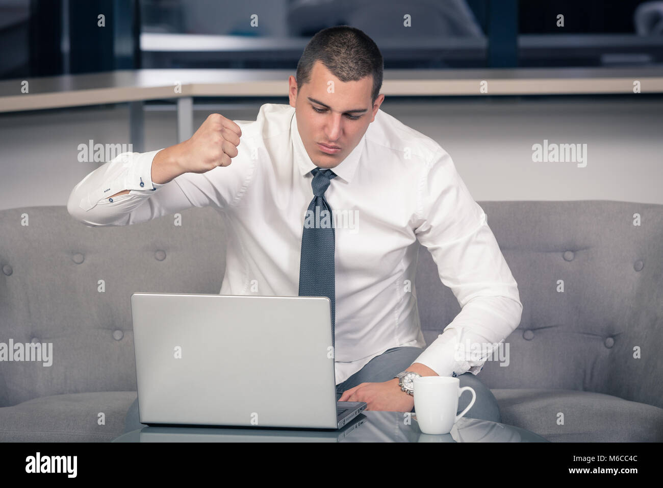 Furious businessman hit a laptop computer. Negative emotion and ...