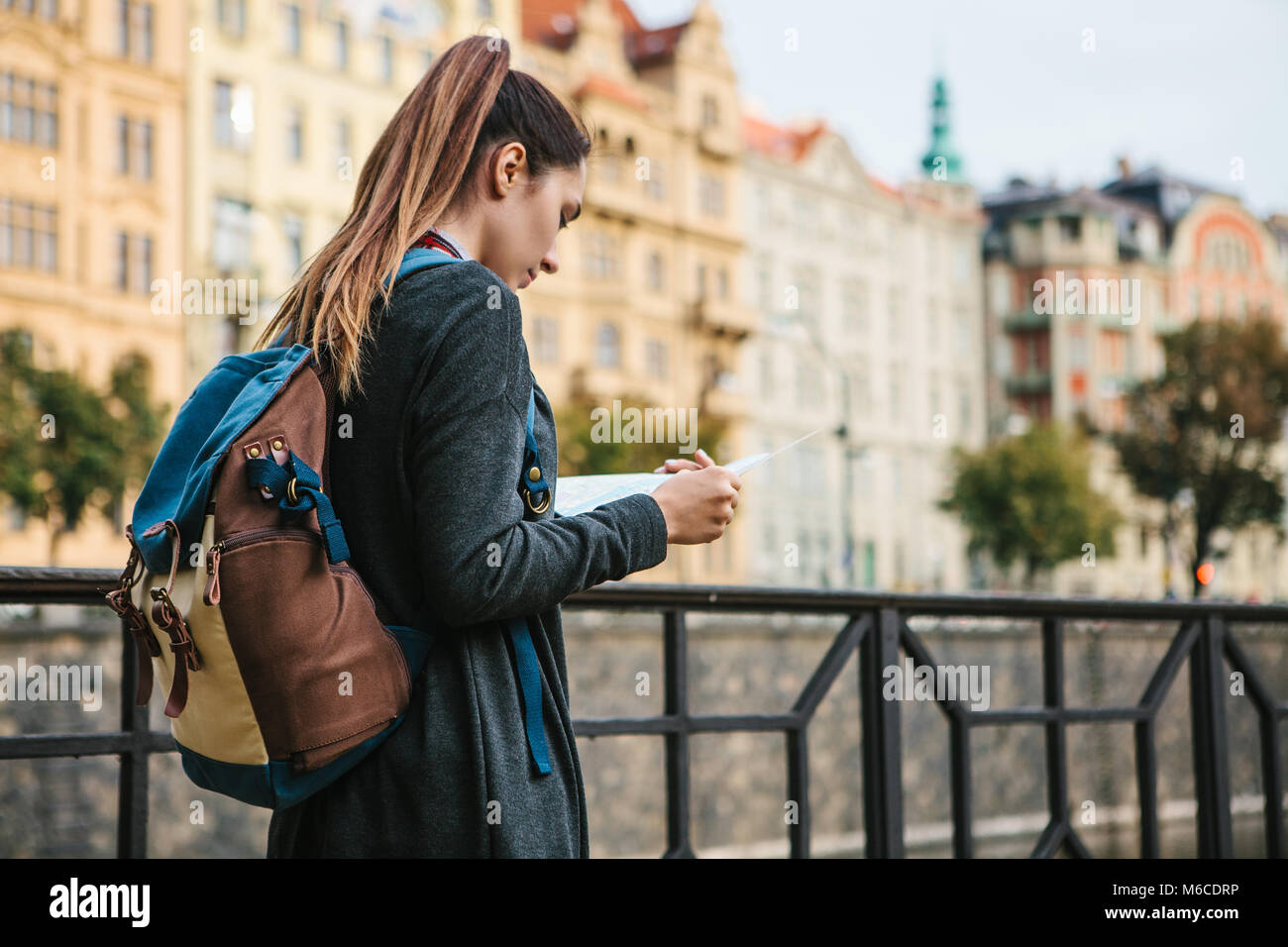 A tourist with a backpack in front of a beautiful old architecture in ...