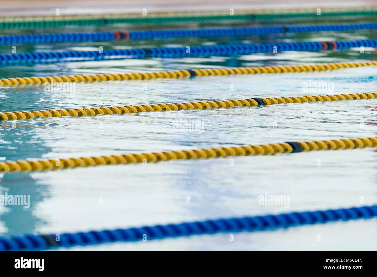 An empty outdoor olympic swimming pool with swimming lanes divided by ...