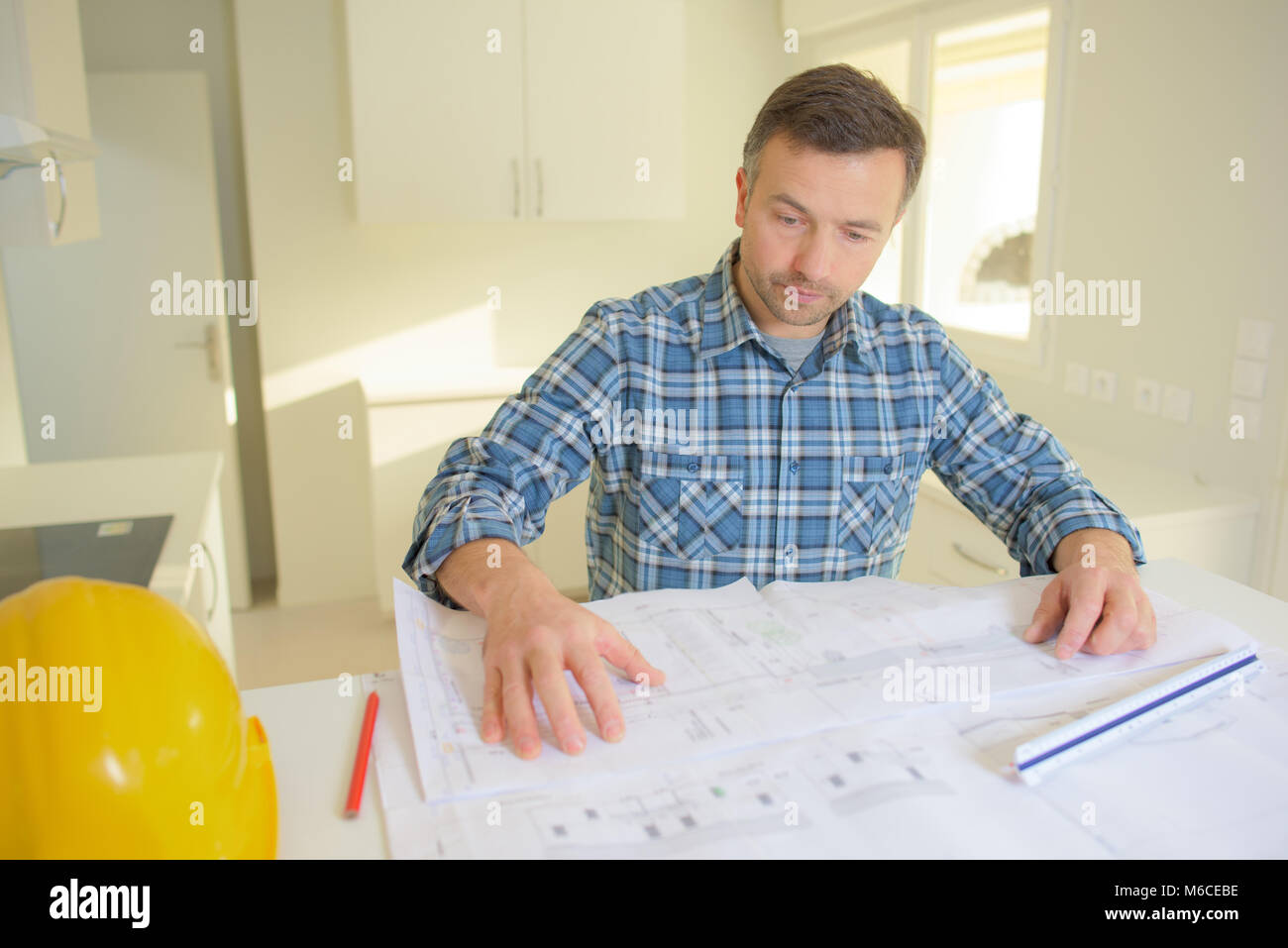architect looking at plan in construction site Stock Photo - Alamy