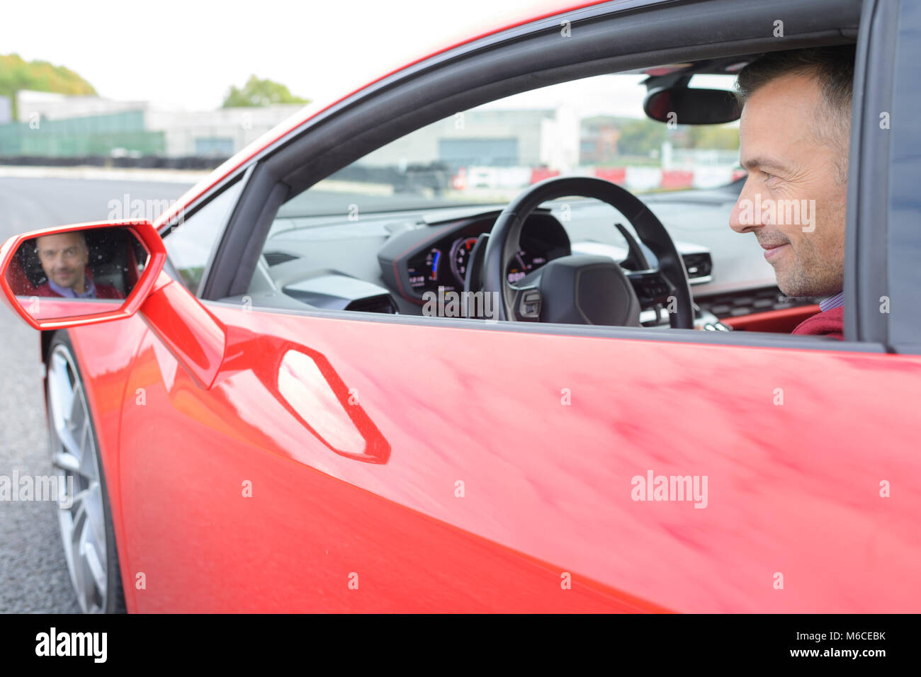 man in sportscar face reflected in wingmirror Stock Photo - Alamy
