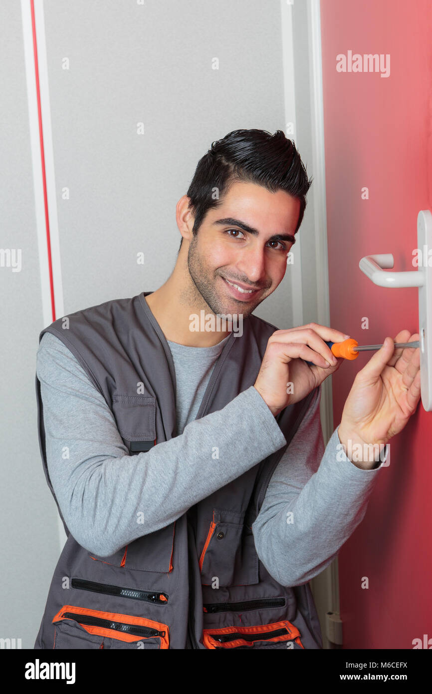 Man fitting door handle Stock Photo - Alamy