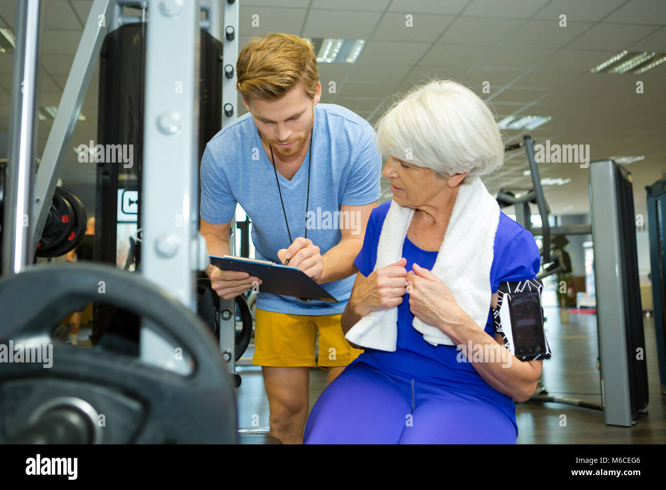 senior woman doing sport exercises with coach or personal trainer Stock ...