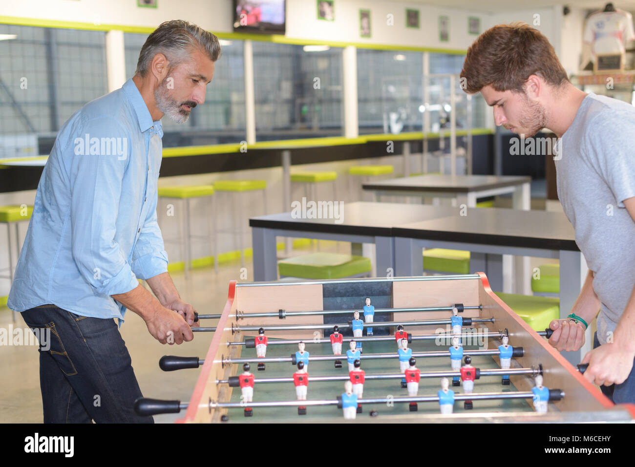 father and son playing table football Stock Photo - Alamy