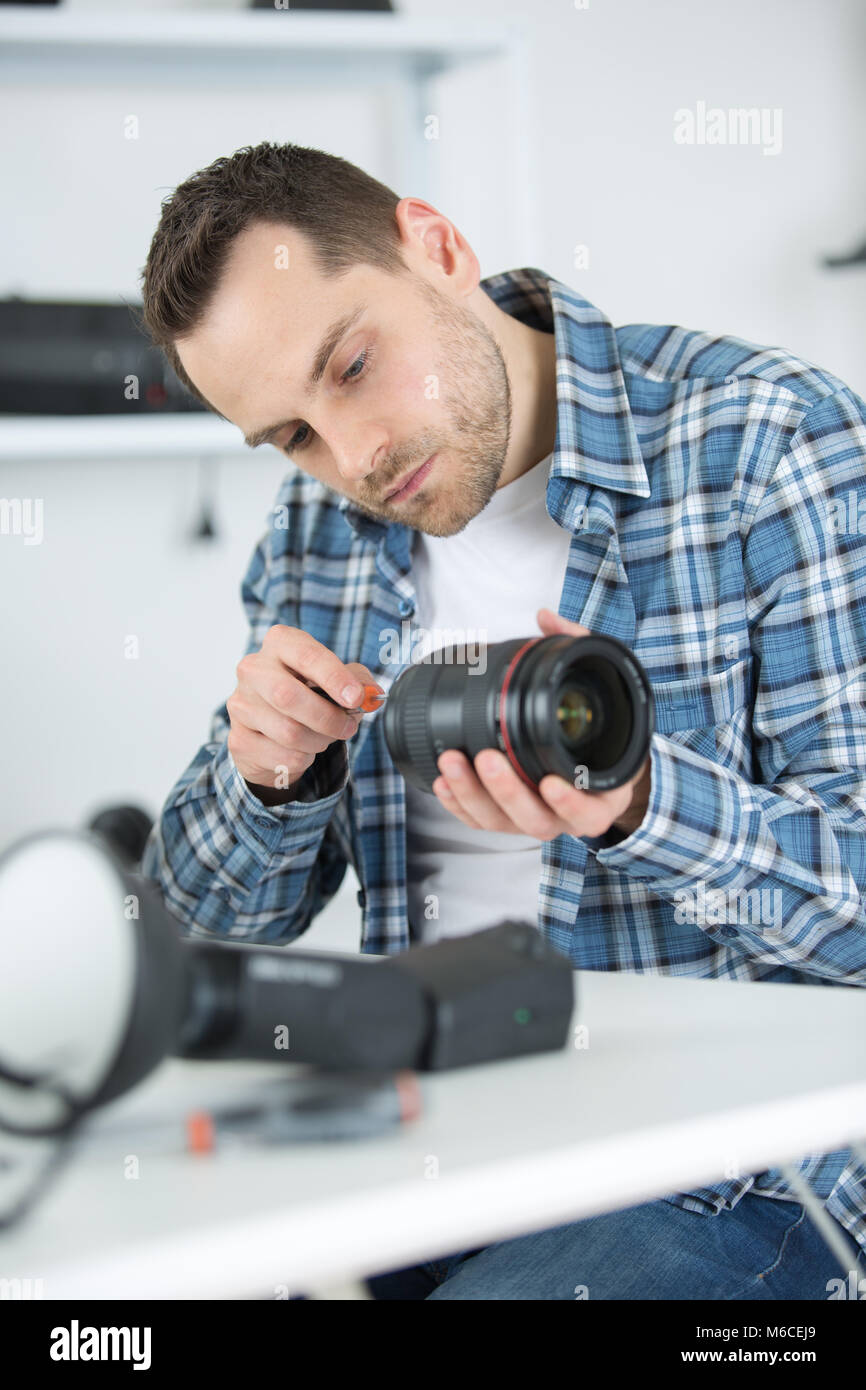 repairman fixing camera Stock Photo - Alamy