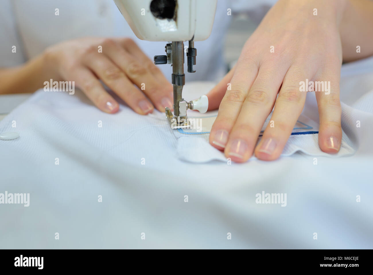 worker sewing a fabric Stock Photo - Alamy