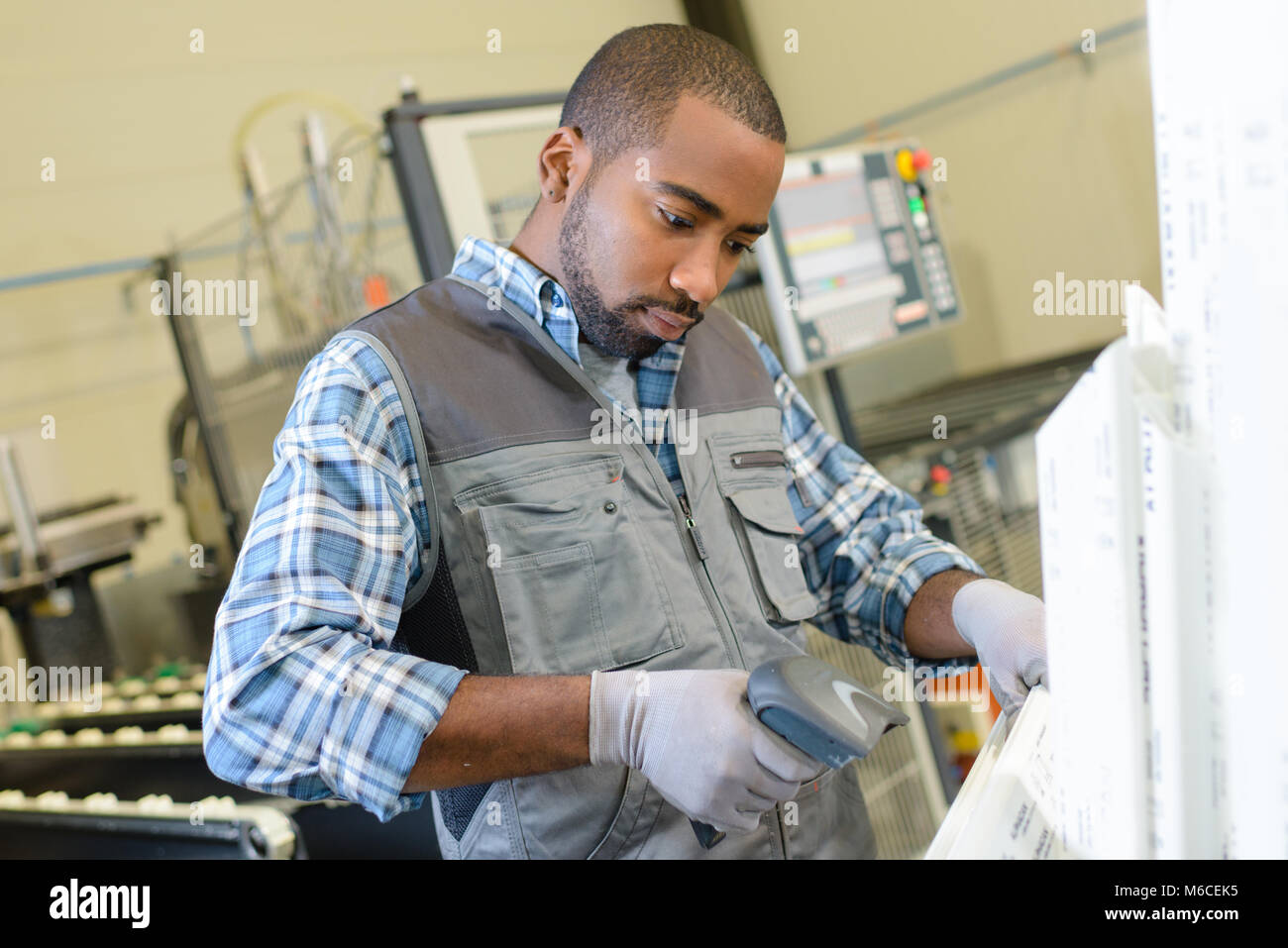 worker using a barcode reader Stock Photo - Alamy