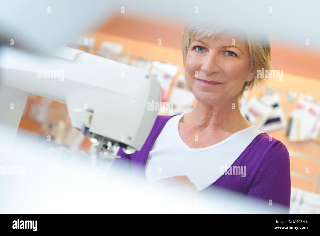 Attractive mature woman sewing hi-res stock photography and images - Alamy