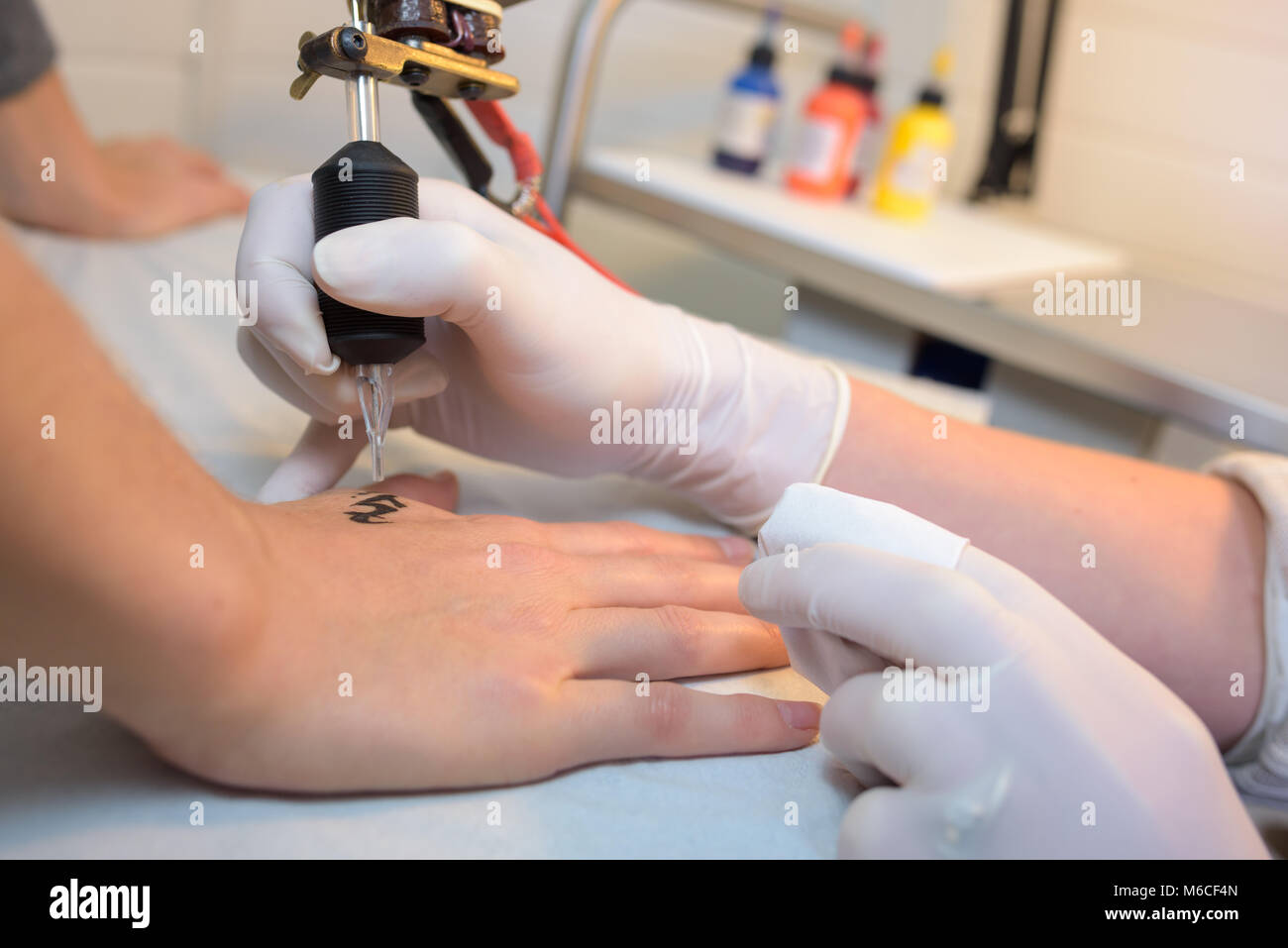 applying a small tattoo Stock Photo - Alamy