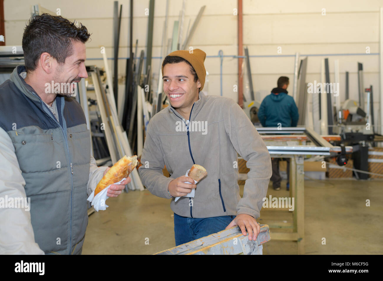 warehouse workers eating sandwiches during lunchbreak Stock Photo - Alamy