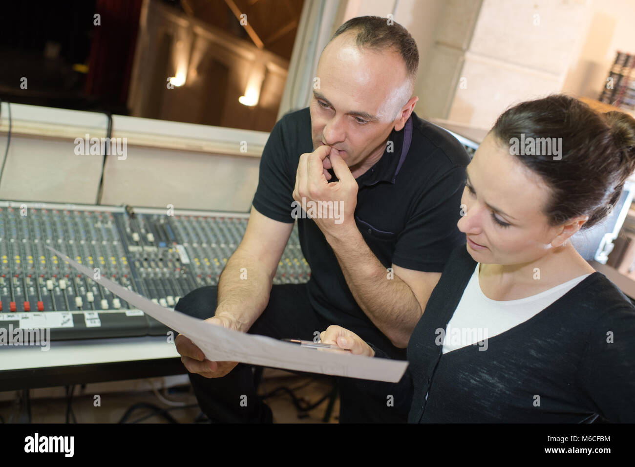 sound engineers working at mixing panel Stock Photo - Alamy