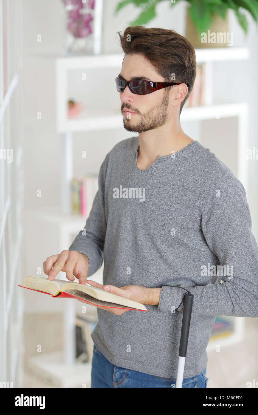 blind man reading a braille book at home Stock Photo - Alamy
