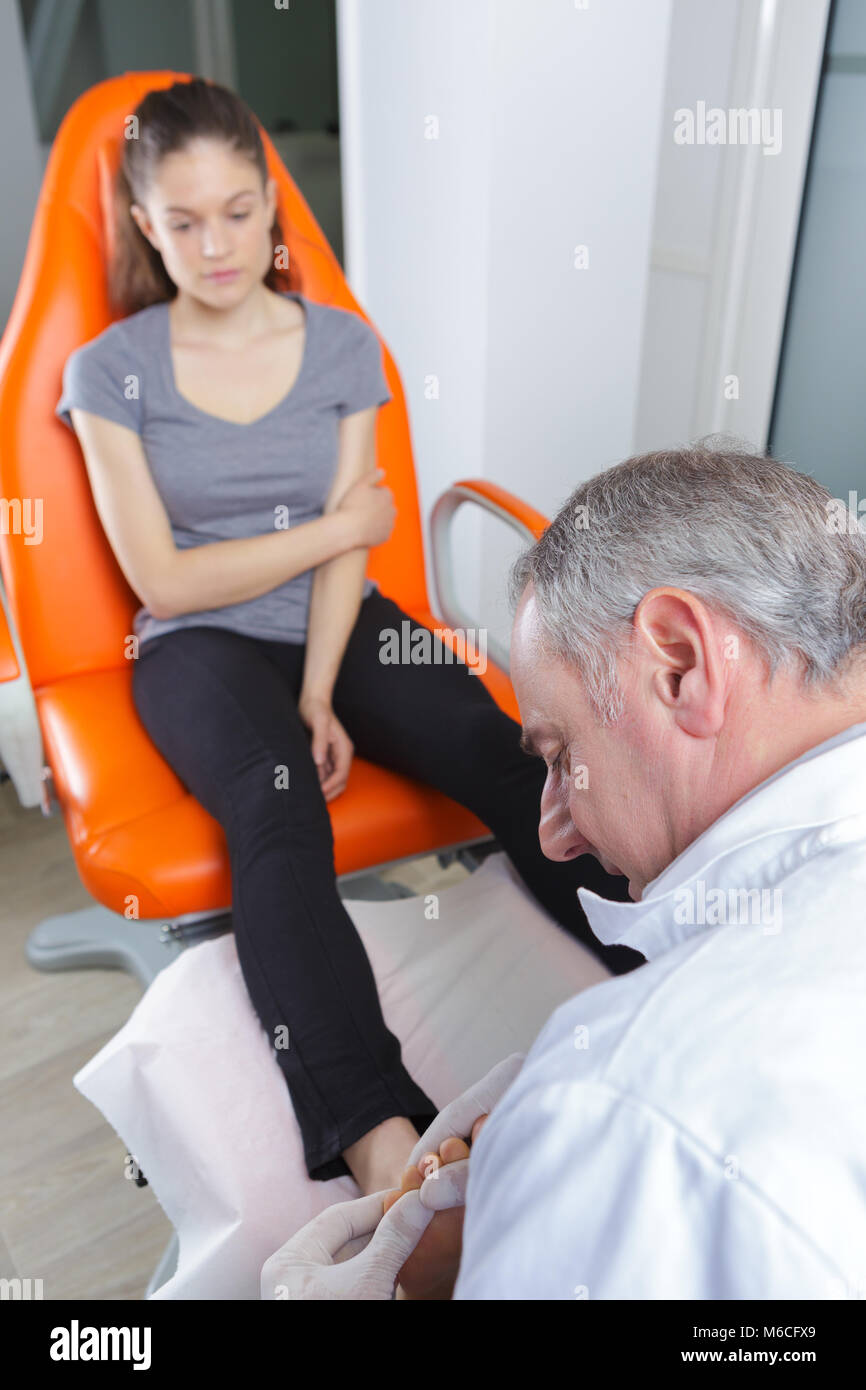 Podiatrist working on patient's foot Stock Photo - Alamy