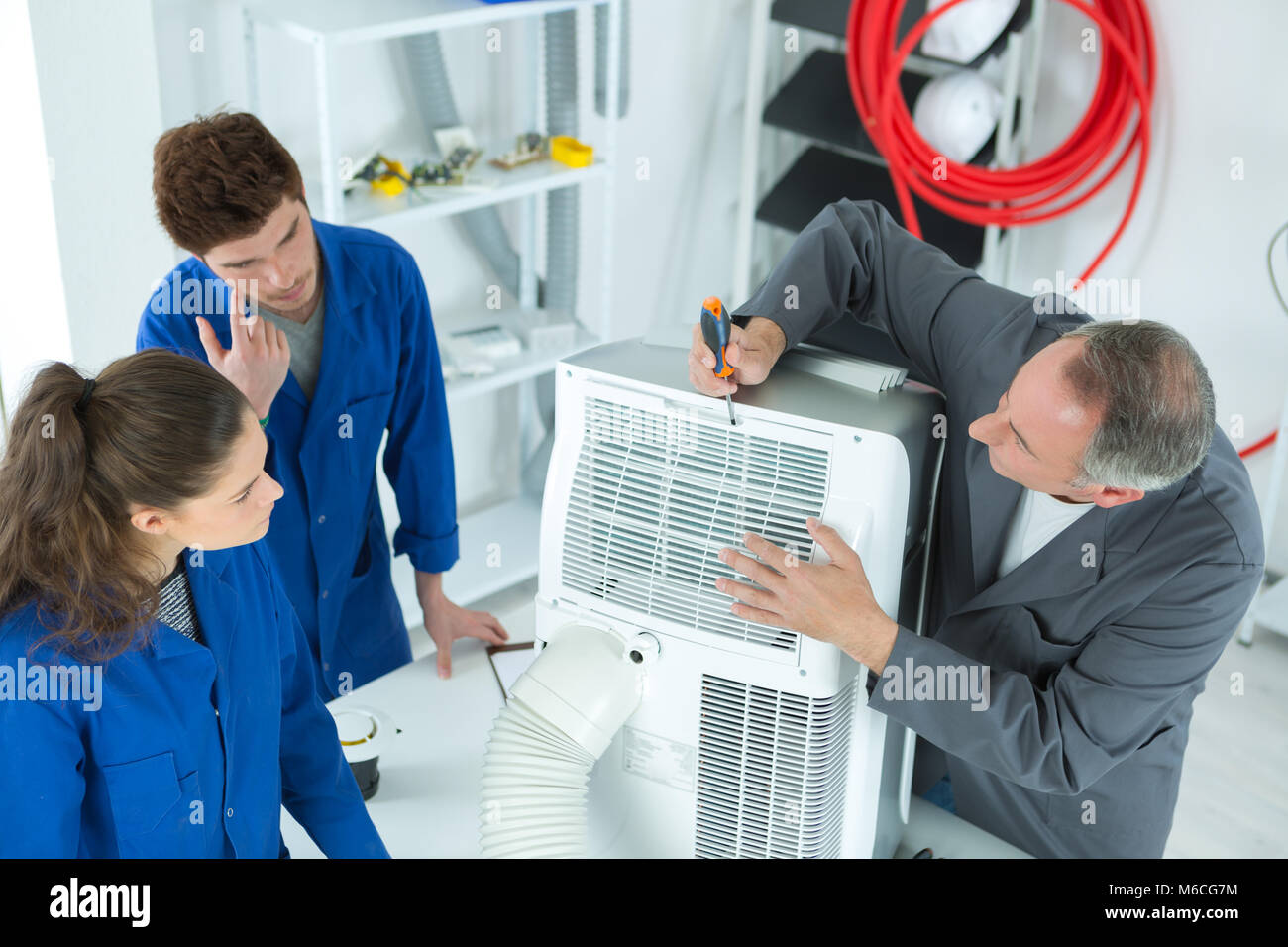 learning to repair an industrial air conditioning compressor Stock ...