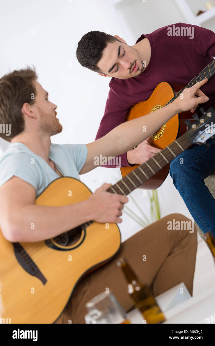 Two young men playing guitar Stock Photo - Alamy