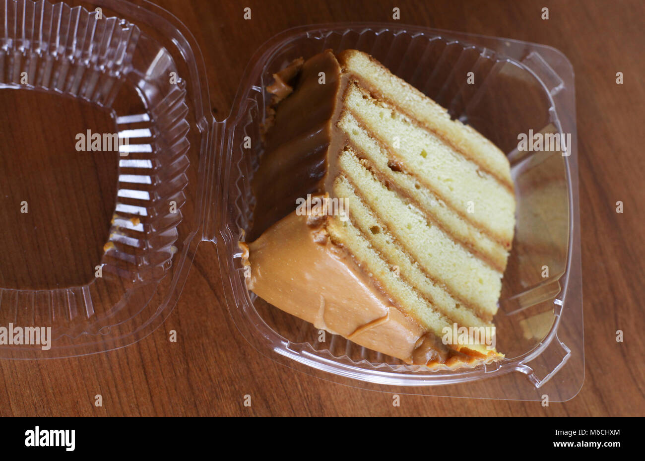 Slice of caramel cake in a clear take out container Stock Photo - Alamy