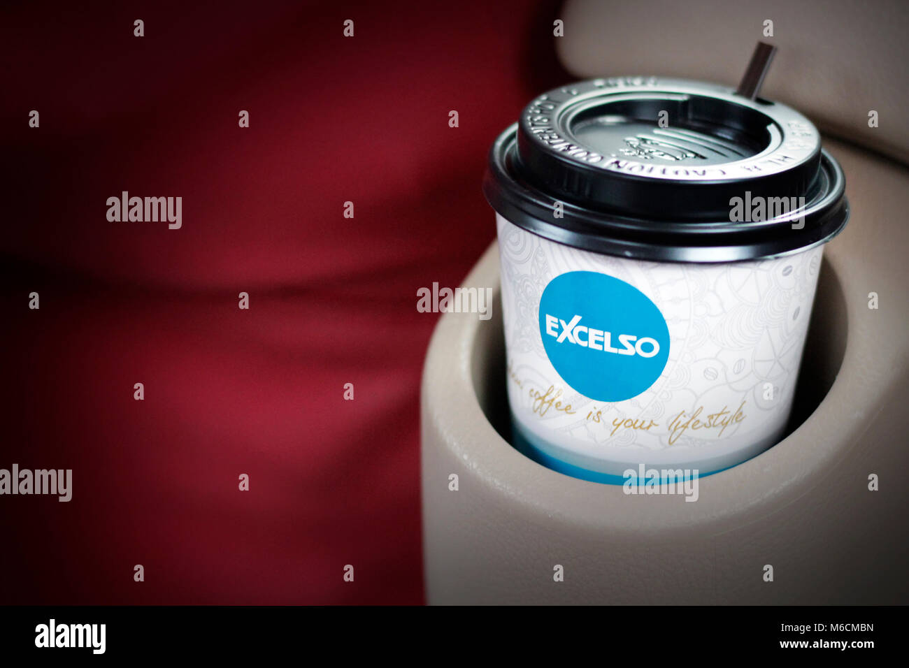 A cup of excelso coffee in a car, a paper cup with a black cover Stock ...