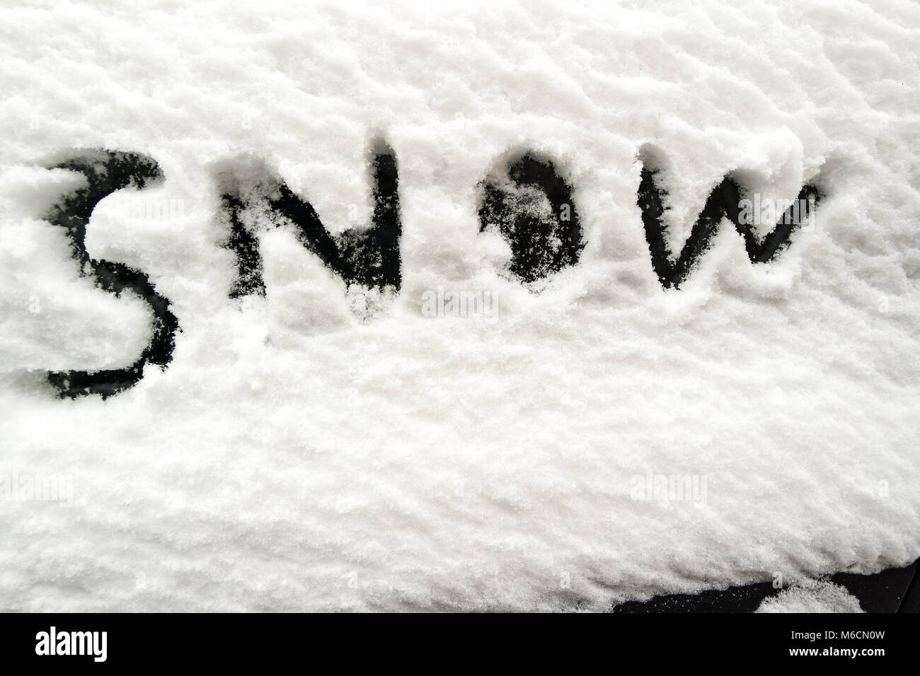 Snow background: Snow written on a car window after winter blizzard ...
