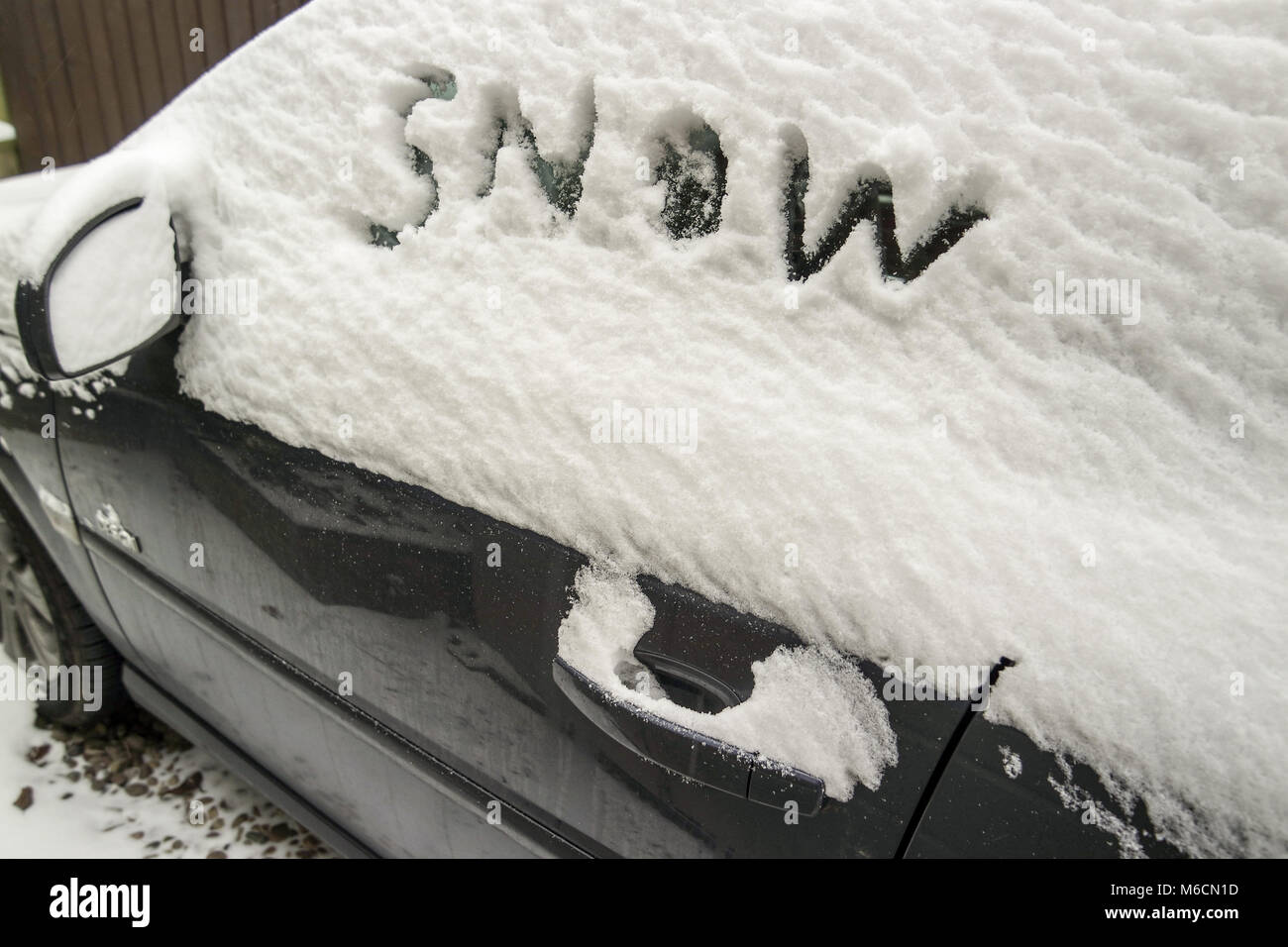 Snow background: Snow written on a car window after winter blizzard ...