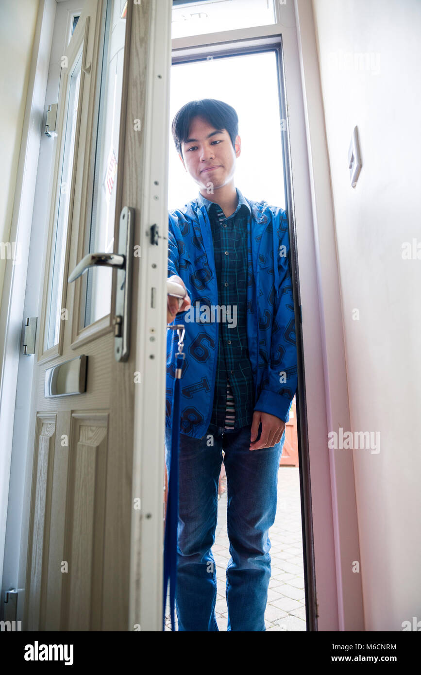 an international overseas student lets himself into his student let ...