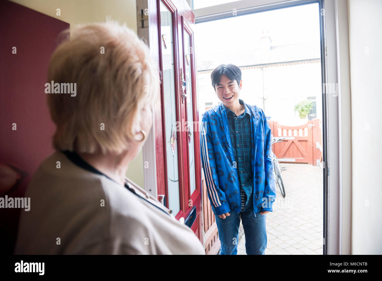 an international overseas student lets himself into his student let ...