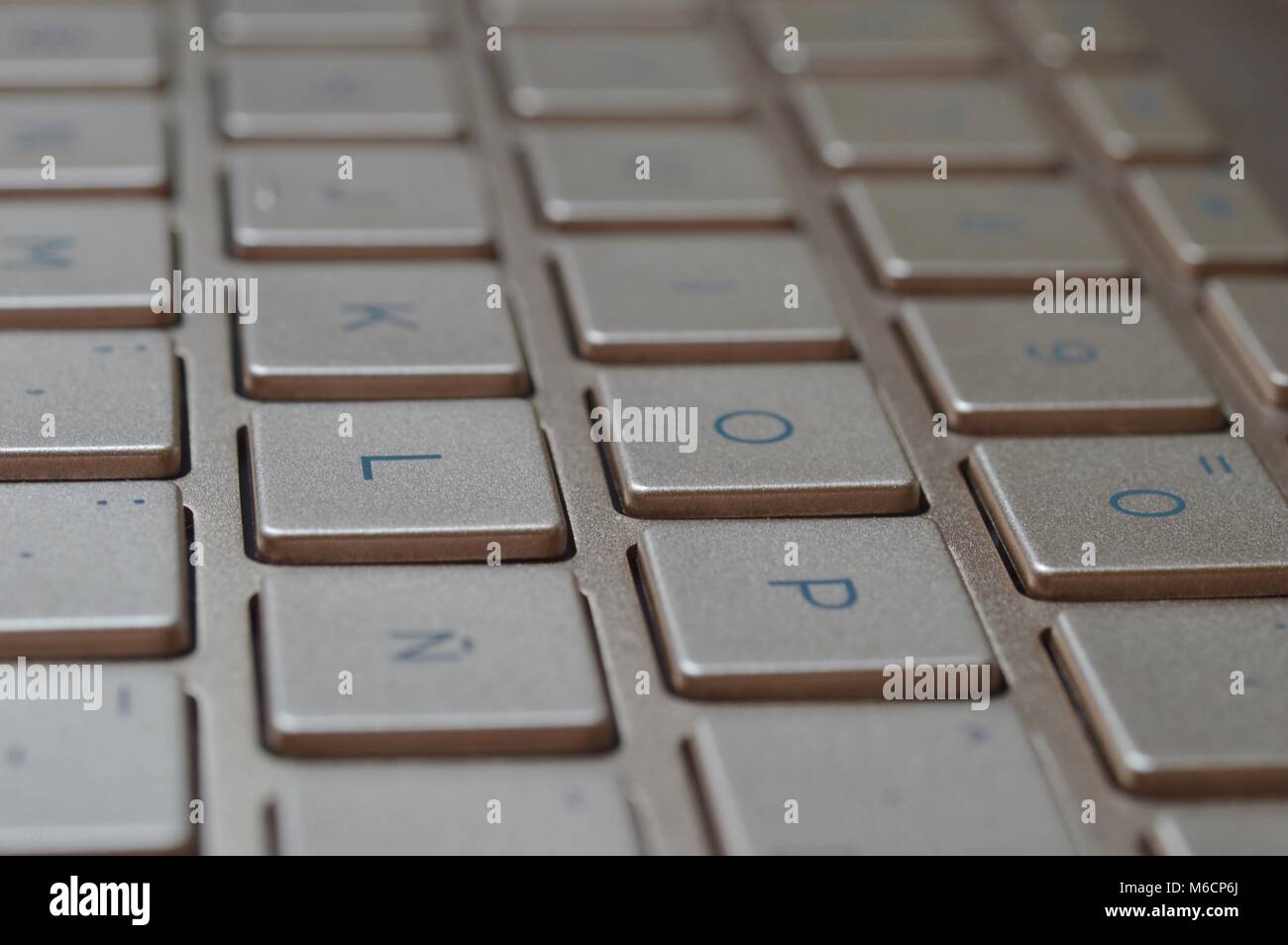 Keyboard of a bronze colored laptop Stock Photo - Alamy