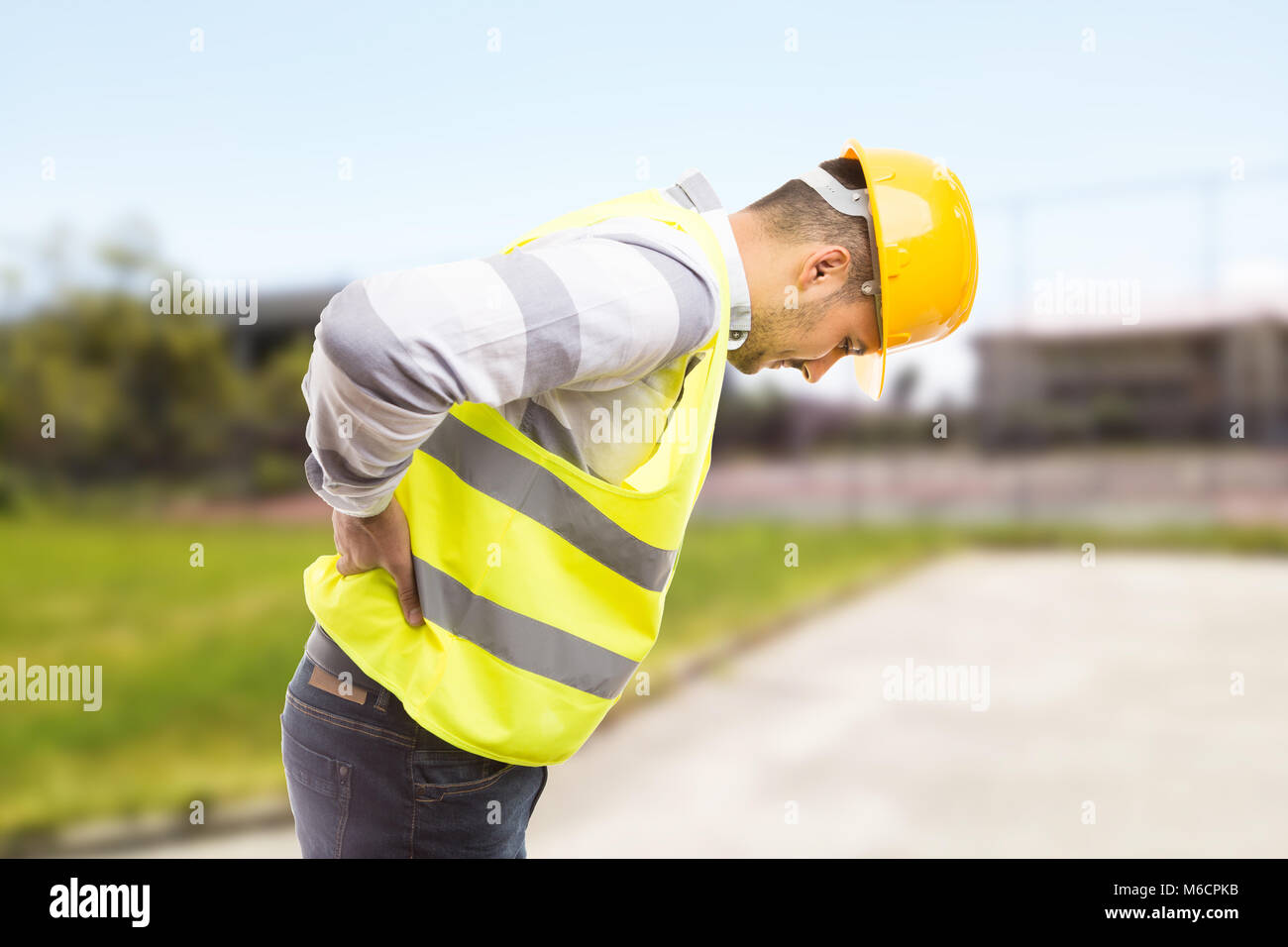 Construction worker feeling backpain in lumbar area pressing painful ...