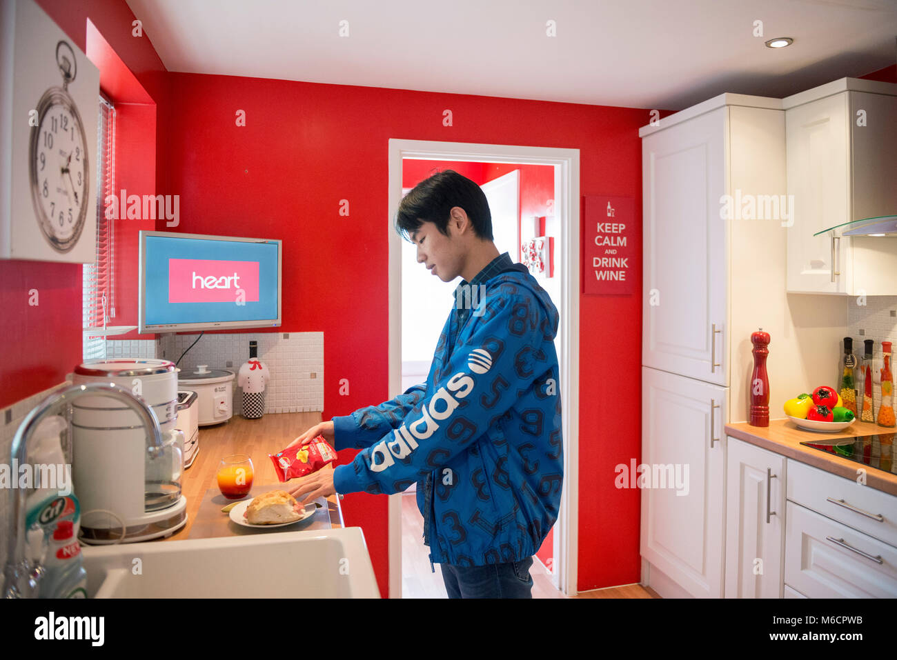 a young asian international overseas student gets and prepares his ...