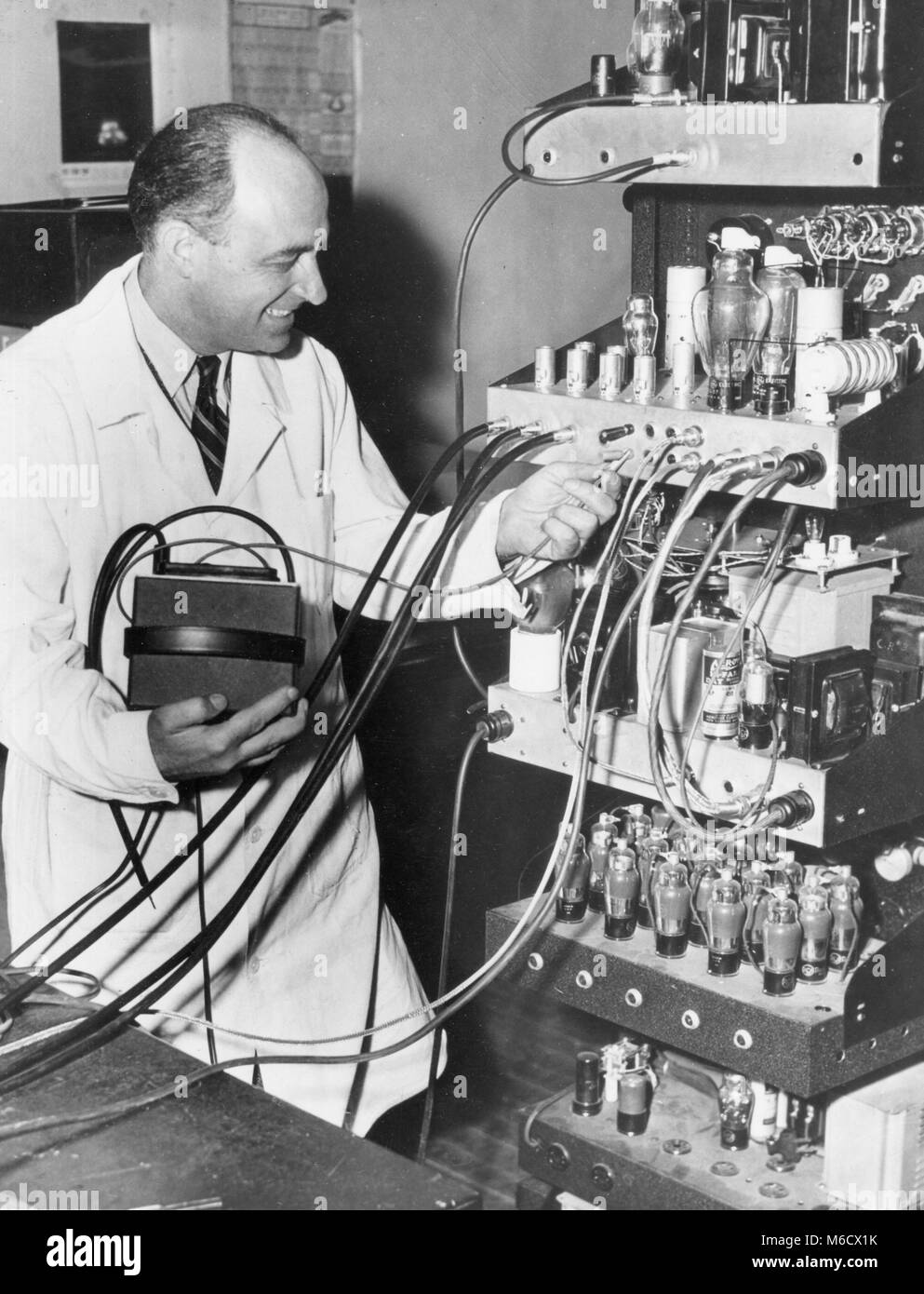 Dr. Enrico Fermi checking electrical circuit of a neutron counter ...