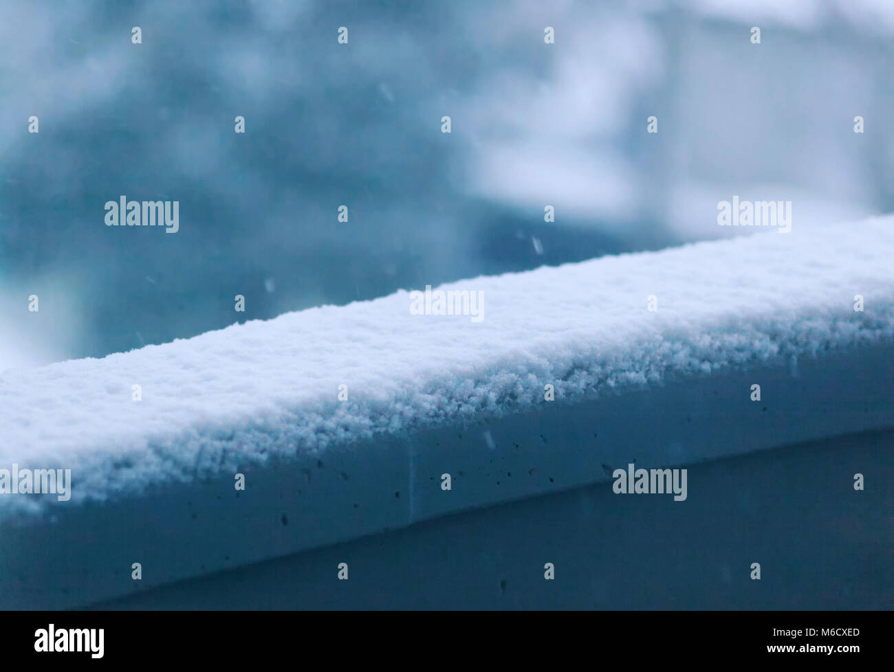 Balcony sill covered with soft snow in the early morning light Stock ...