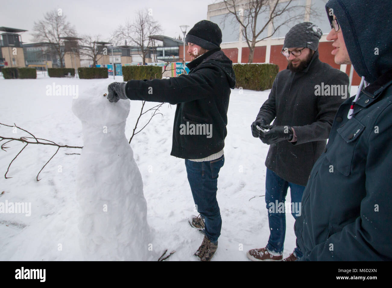 Bristol, UK. 2nd Mar, 2018. Workers on their lunch break building a ...