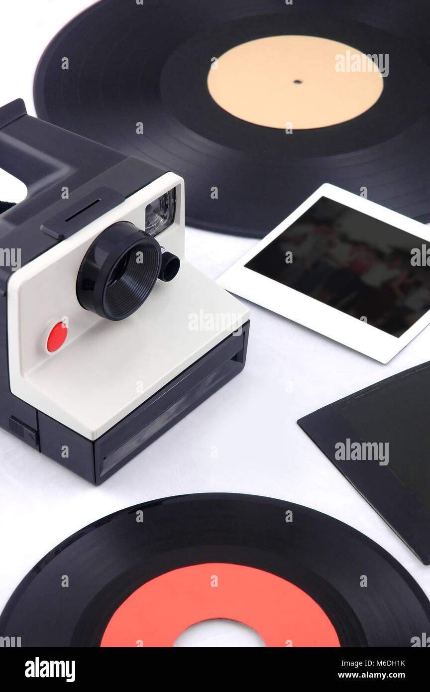 Old instant camera with vinyl and instant photos - eighties Stock Photo ...