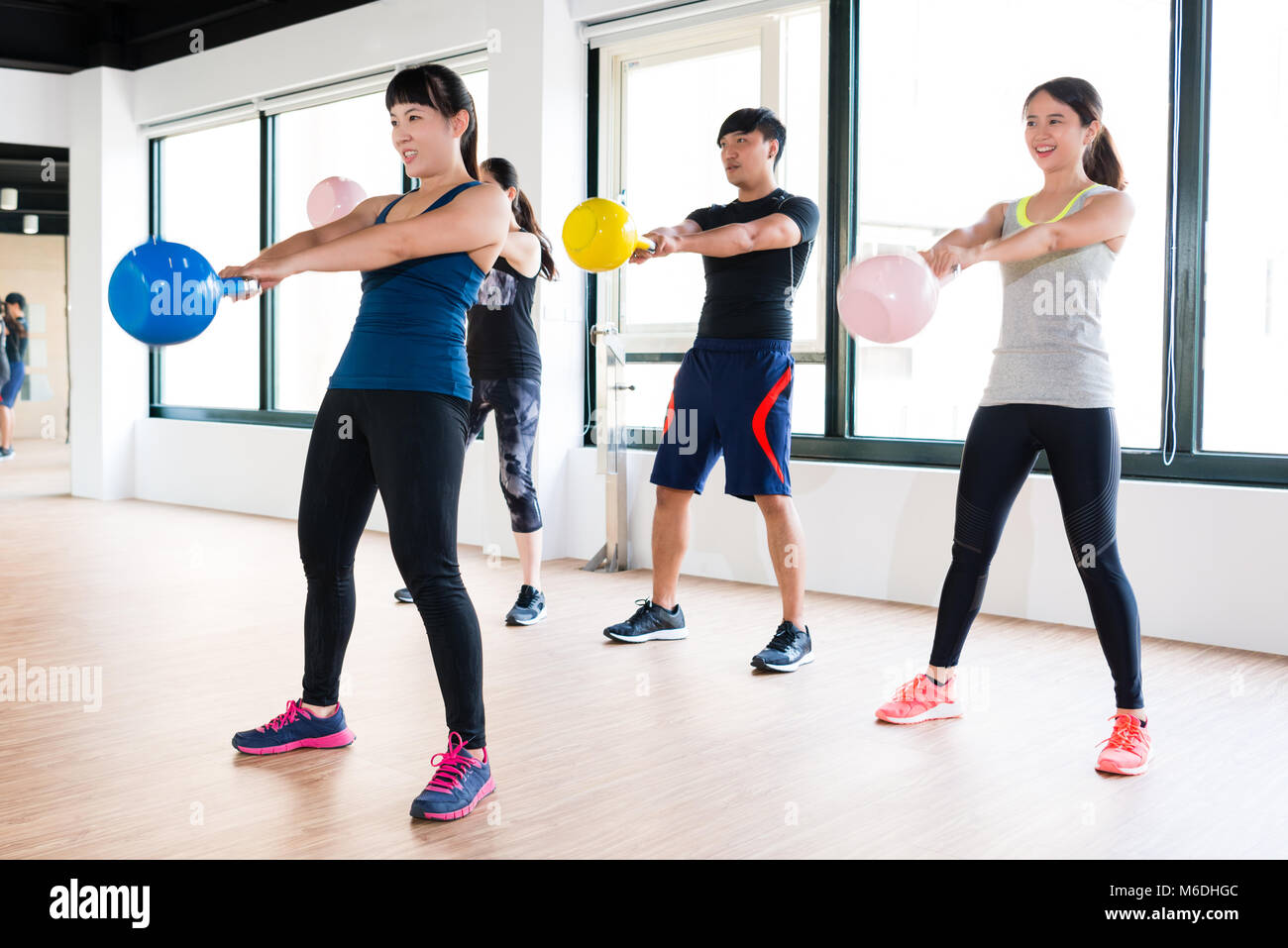 male and female fitness player exercise with kettlebell together with a ...