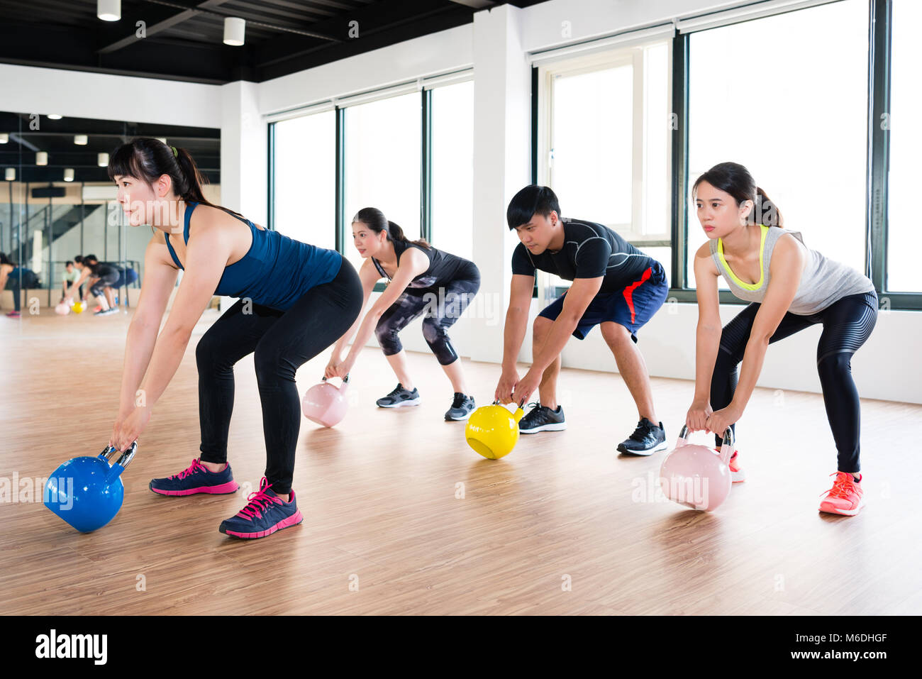 team of fitness player exercise with kettlebell together in the ...