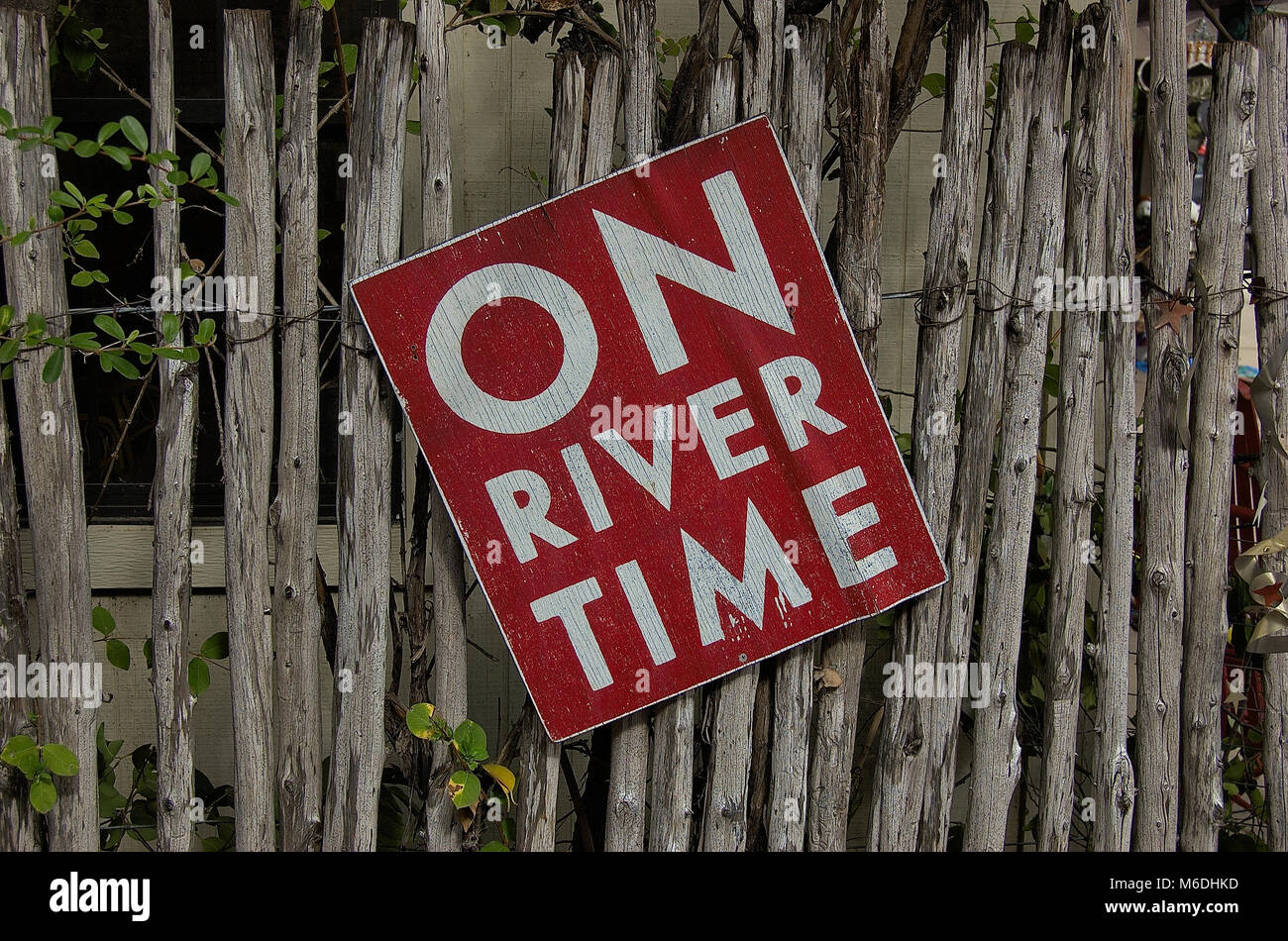 Sign that says On River Time Stock Photo - Alamy