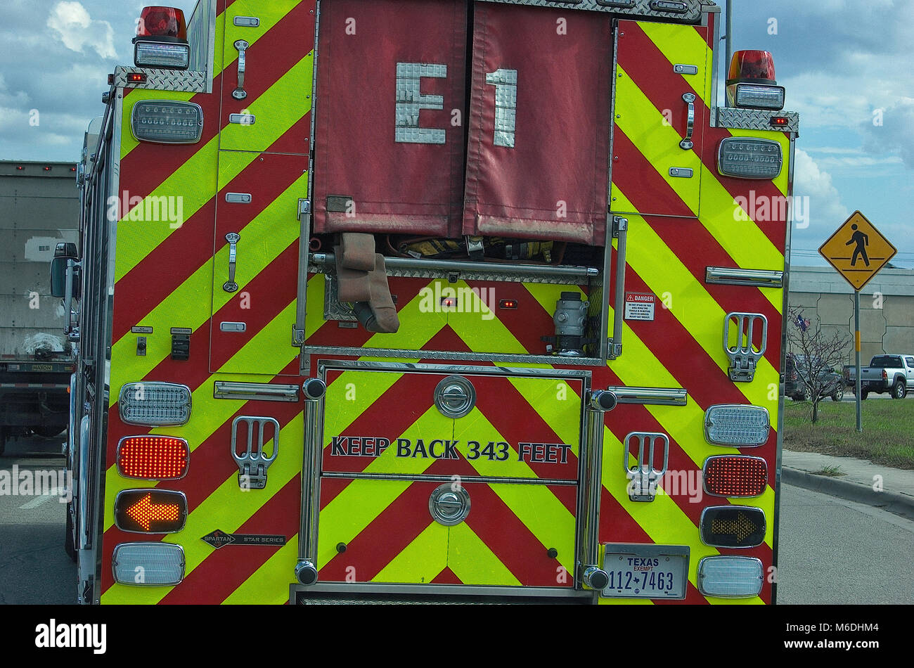 Bright neon yellow and red striped pattern on the back of a fire truck ...