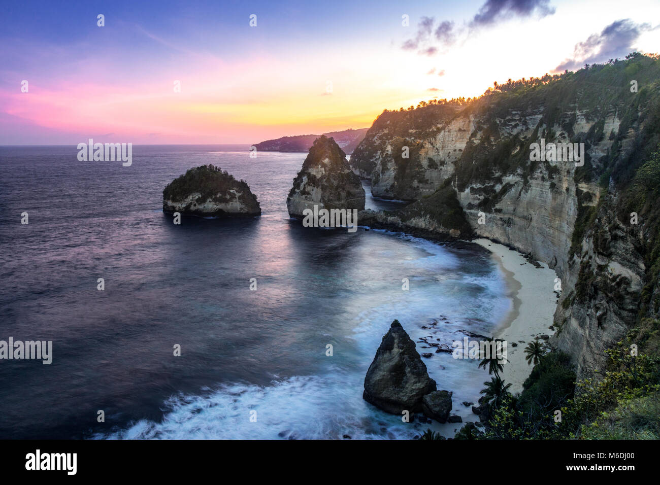 The beautiful pink sunset at Atuh Beach, Indonesia Stock Photo - Alamy
