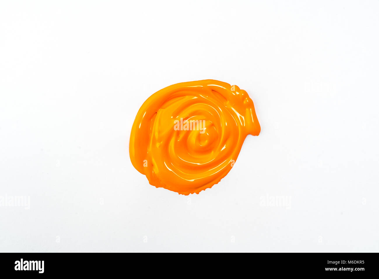 a drop of acrylic orange color on a white surface Stock Photo - Alamy