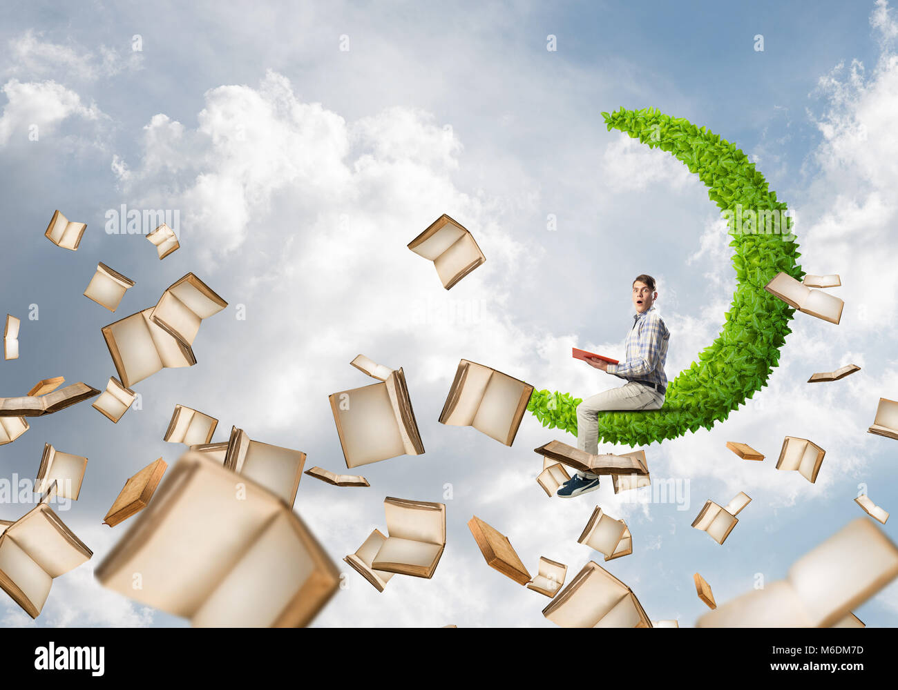 Man reading book and many of them flying in air Stock Photo - Alamy
