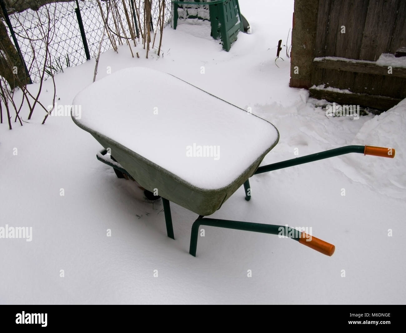 Wheelbarrow snow hi-res stock photography and images - Alamy