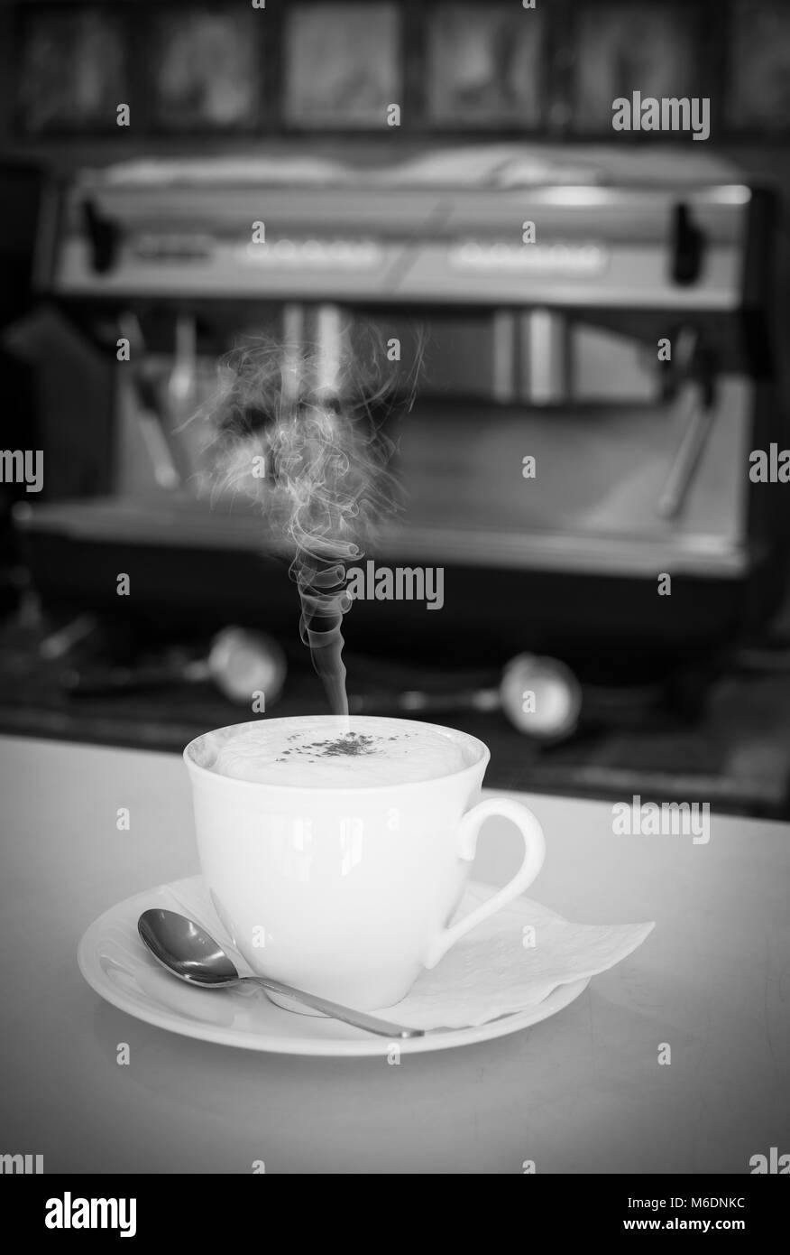 Coffee cup on machine blur background Stock Photo - Alamy