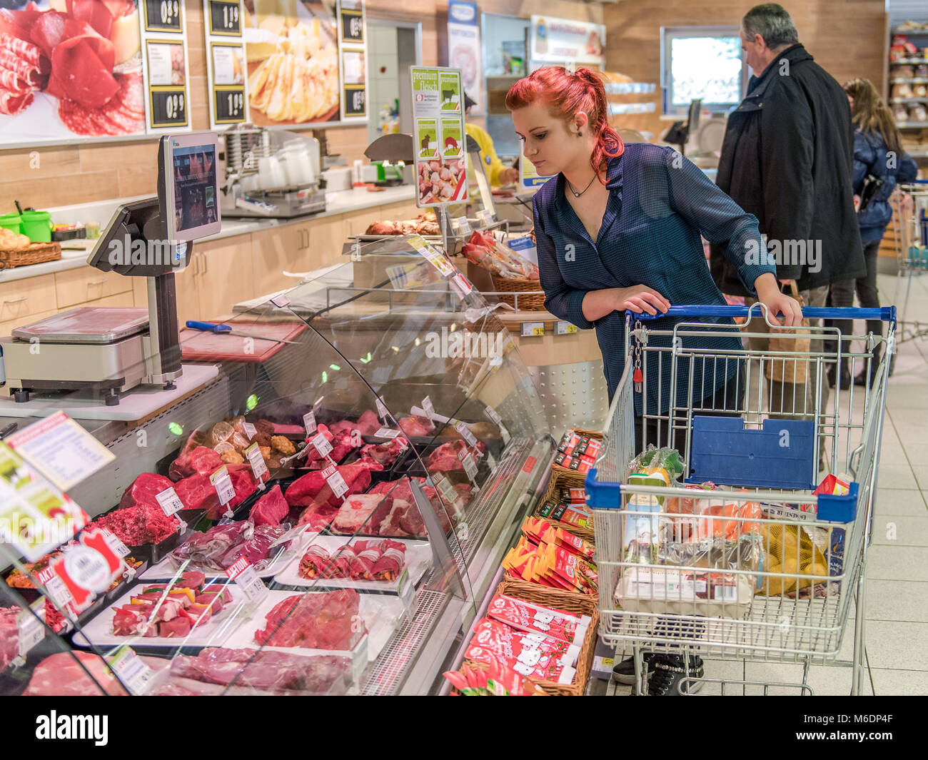 Woman purchasing raw meat hi-res stock photography and images - Alamy