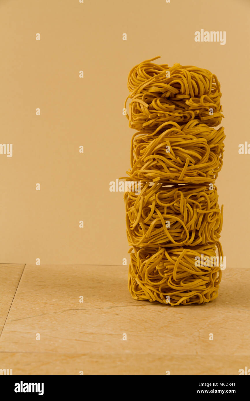 Stack of four noodle nests, copy space to left Stock Photo - Alamy