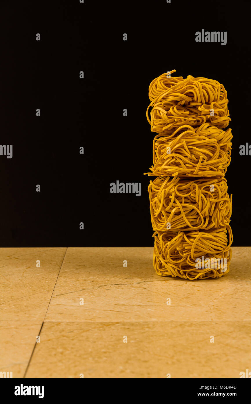 Stack of four noodle nests, copy space to left Stock Photo - Alamy