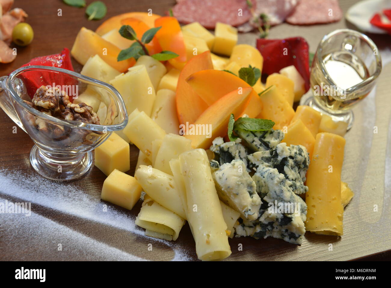 Assorted sliced cheese with mildew, blue, brie, swiss , cheddar ...