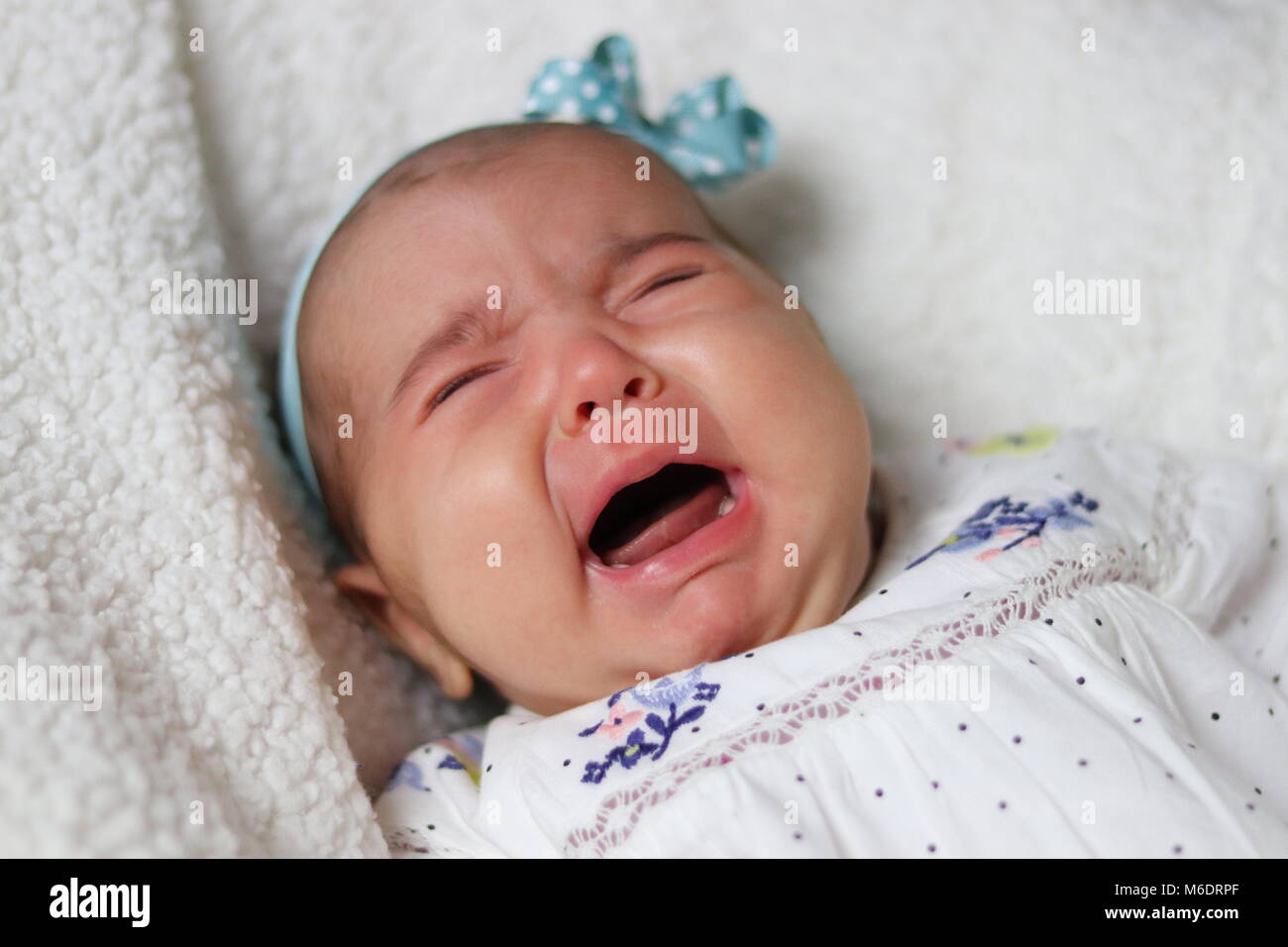 Littel baby crying Stock Photo - Alamy