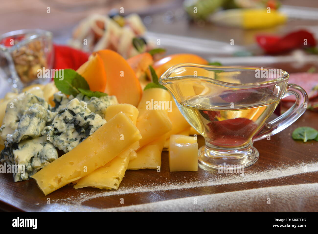 Assorted sliced cheese with mildew, blue, brie, swiss , cheddar ...