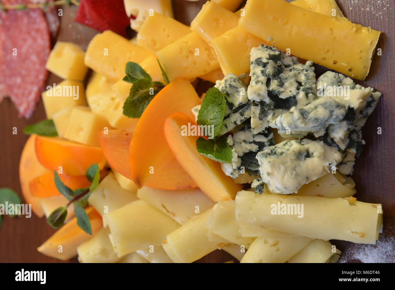 Assorted sliced cheese with mildew, blue, brie, swiss , cheddar ...